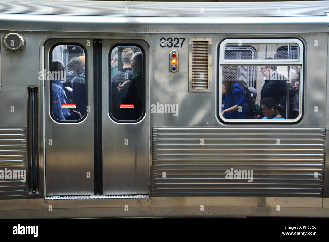Commuters take a crowded El train to work in the Loop on Chicago's ...