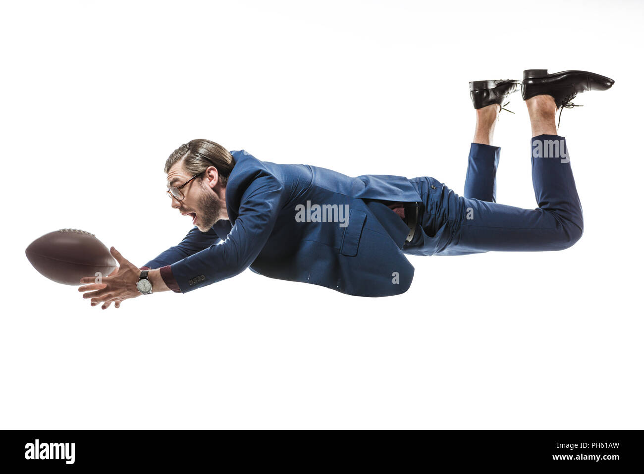 side view of businessman catching rugby ball while falling isolated on ...