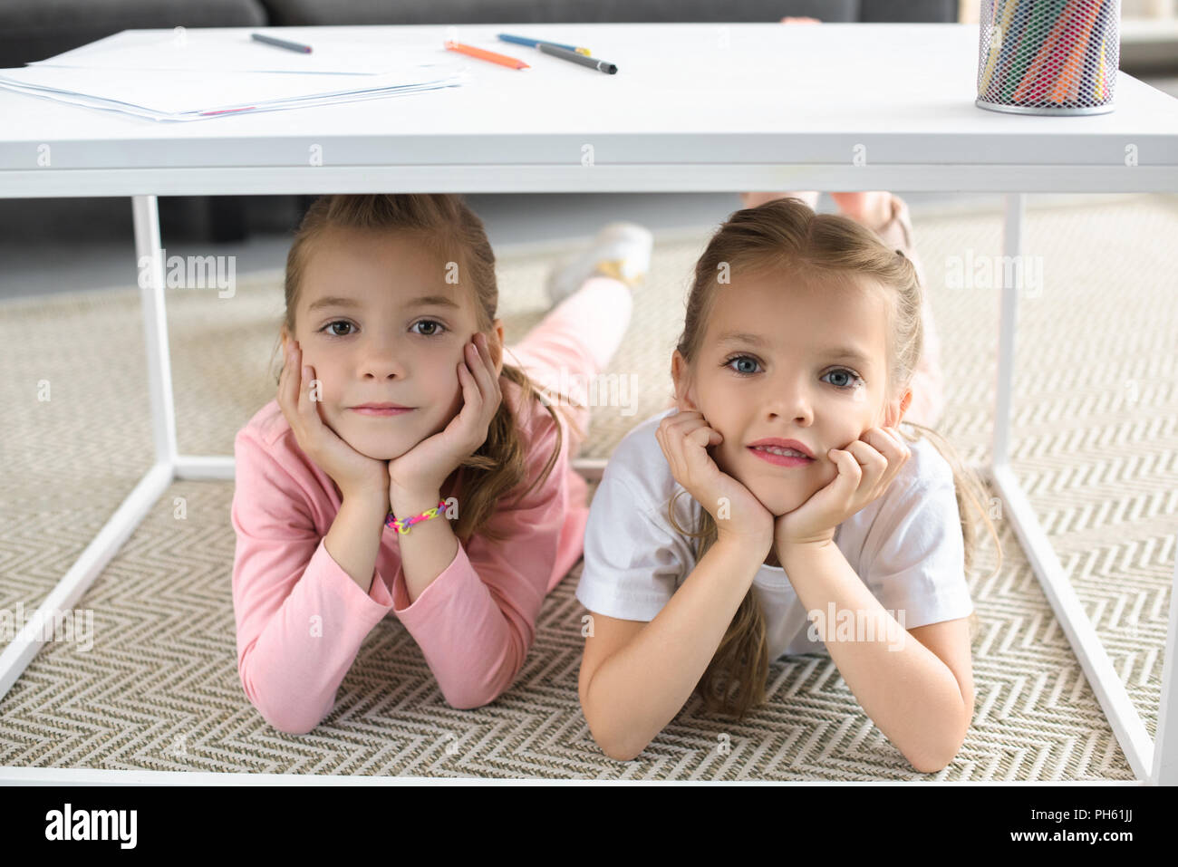 Children under table hi-res stock photography and images - Alamy