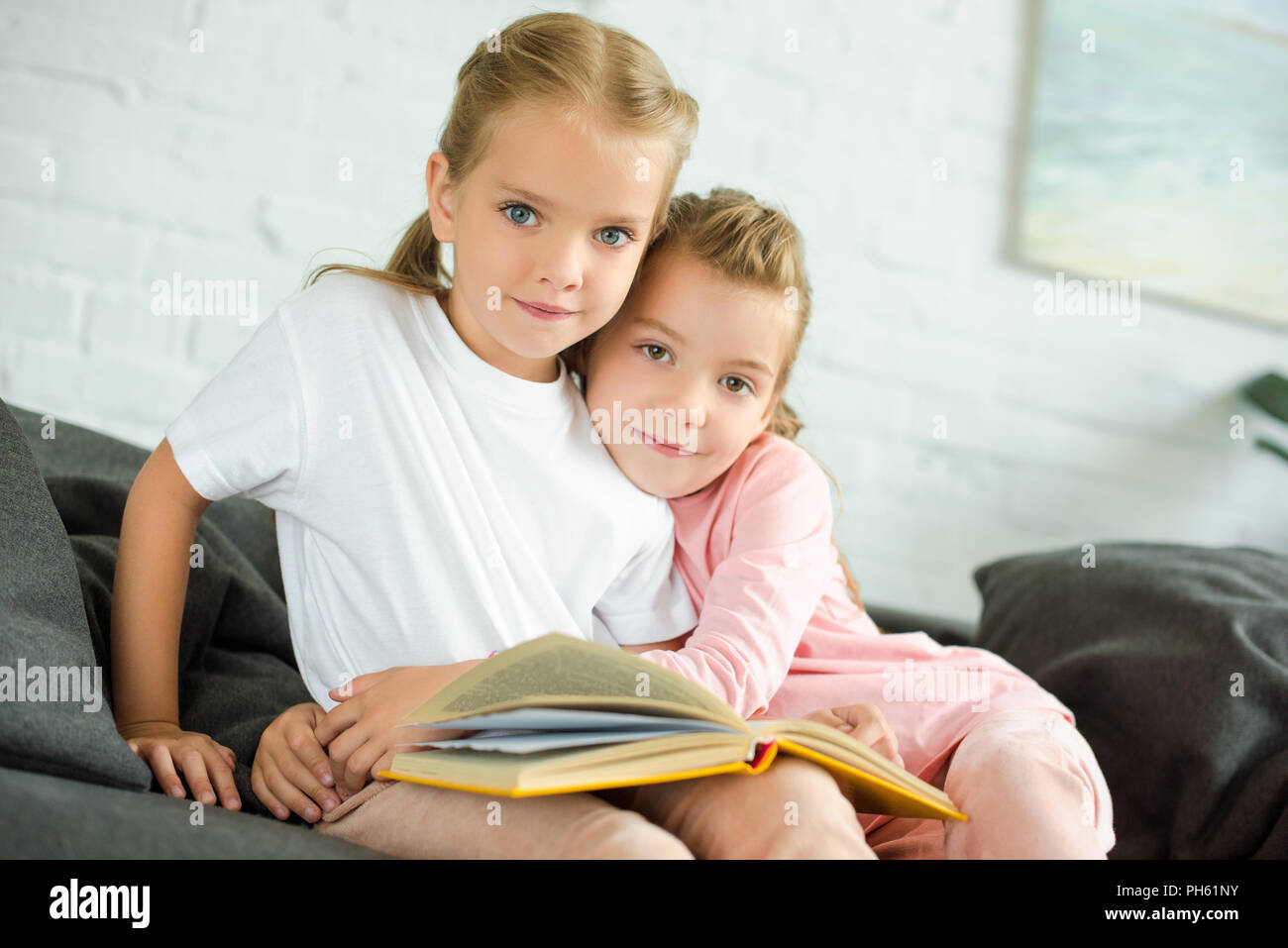 Kids hugging book hi-res stock photography and images - Alamy