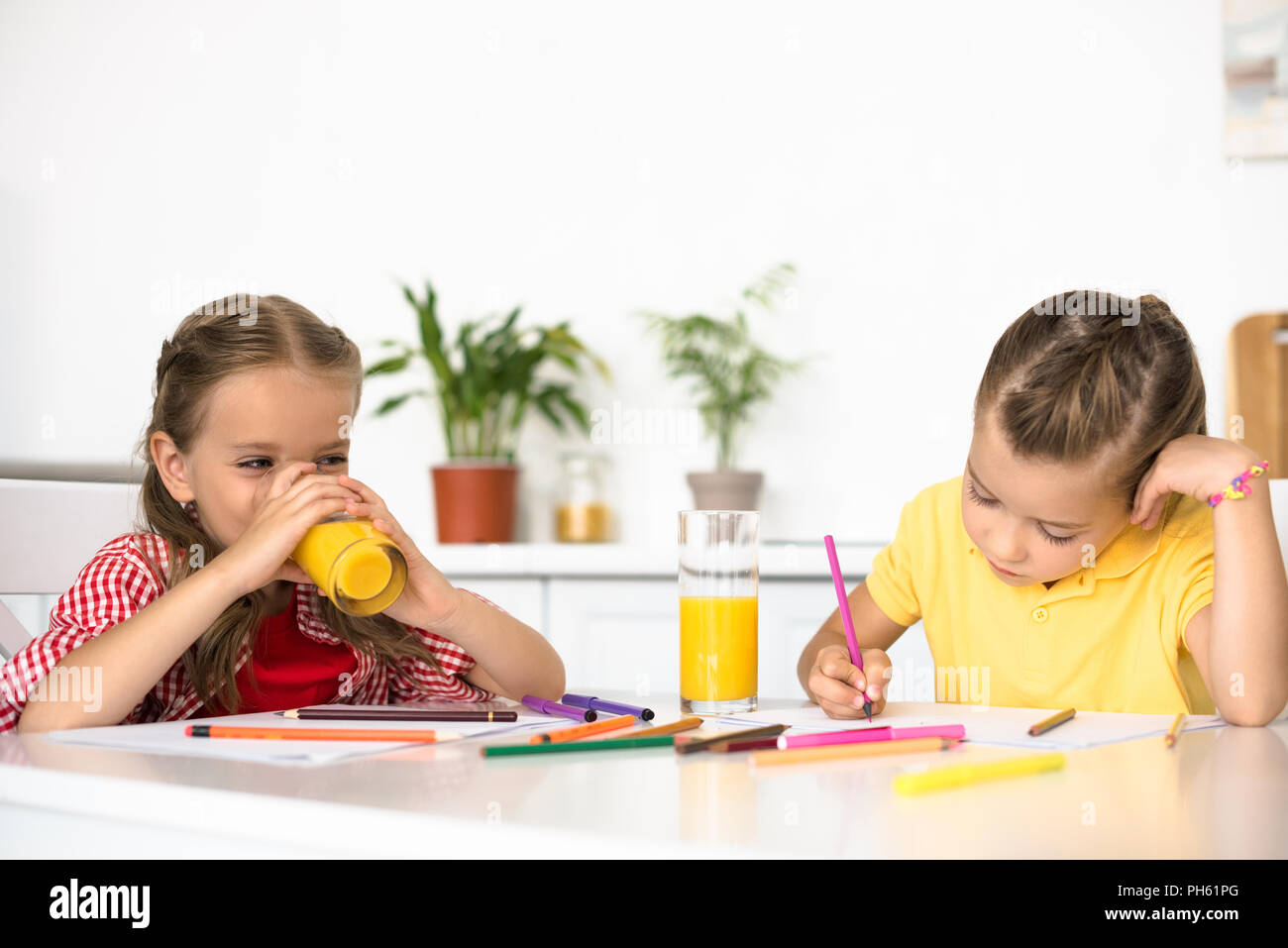 cute little kids drawing pictures at table at home Stock Photo - Alamy