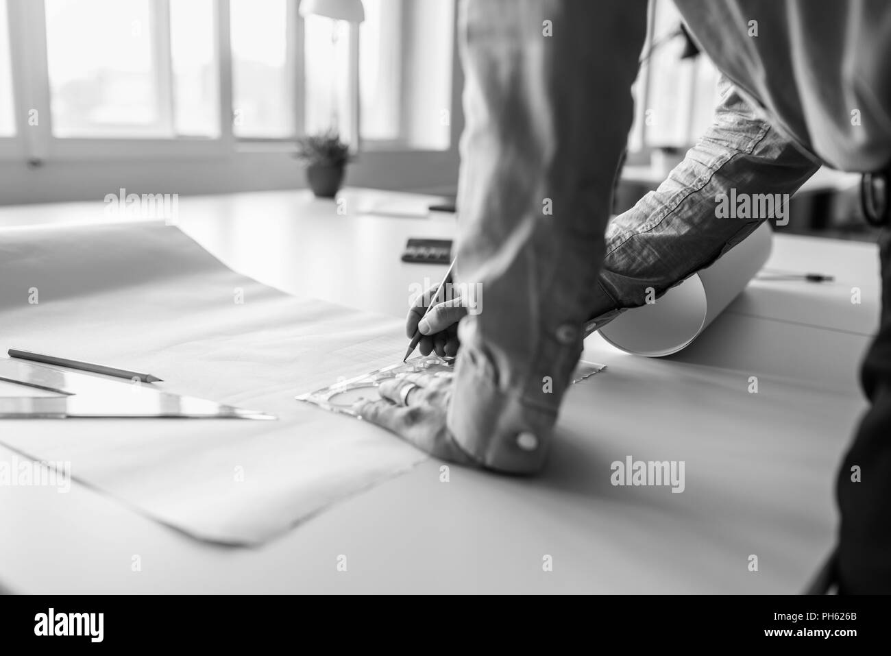 Monochrome image of architect with an innovative vision drawing the ...