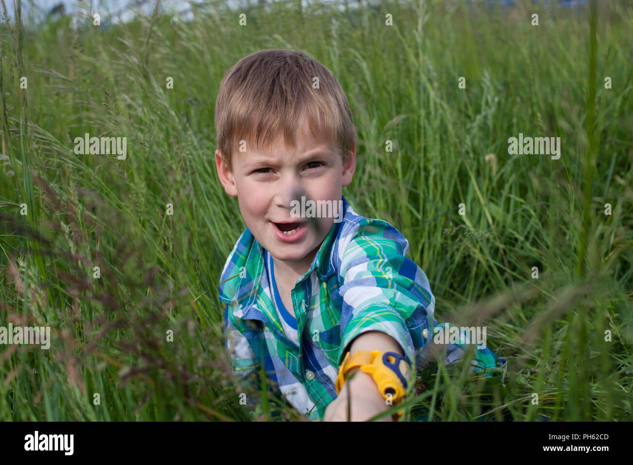 A boy having fun on a medow Stock Photo - Alamy