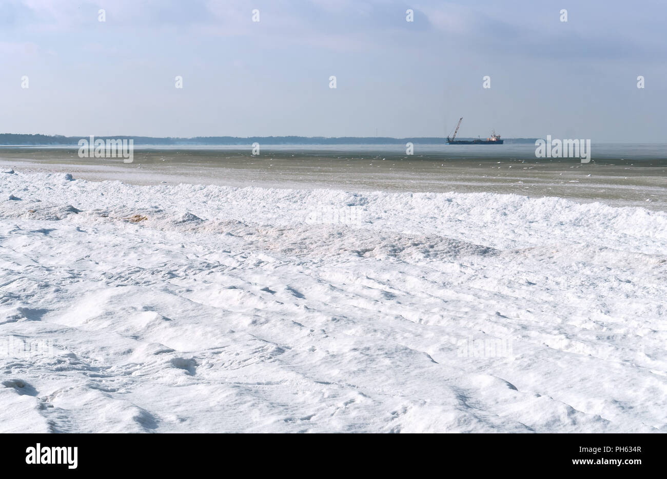 ice sludge in the sea, oil platform in the winter sea on the horizon ...