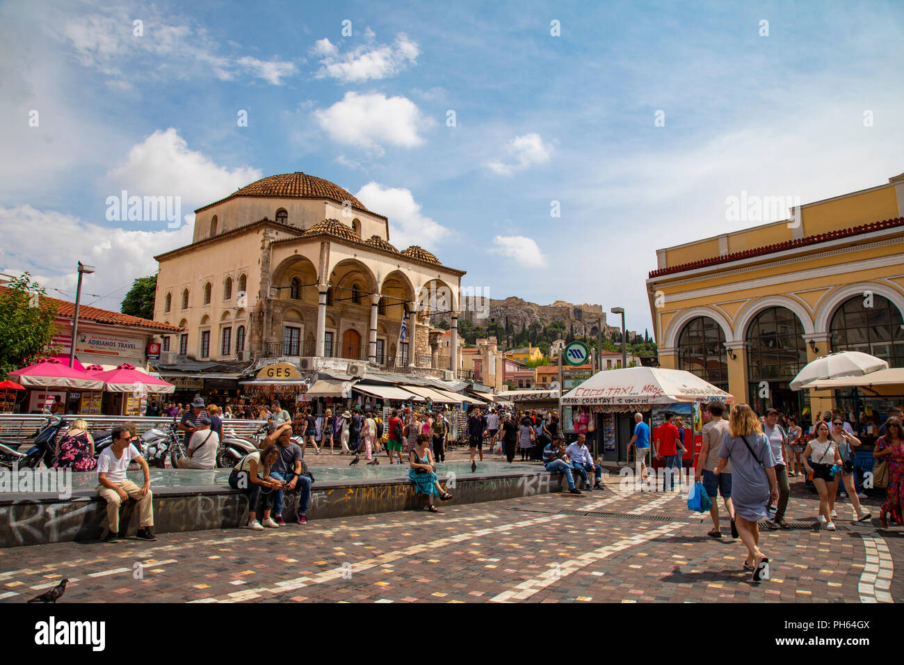 Tourists and people at the old mosque and metro station in Monastiraki ...