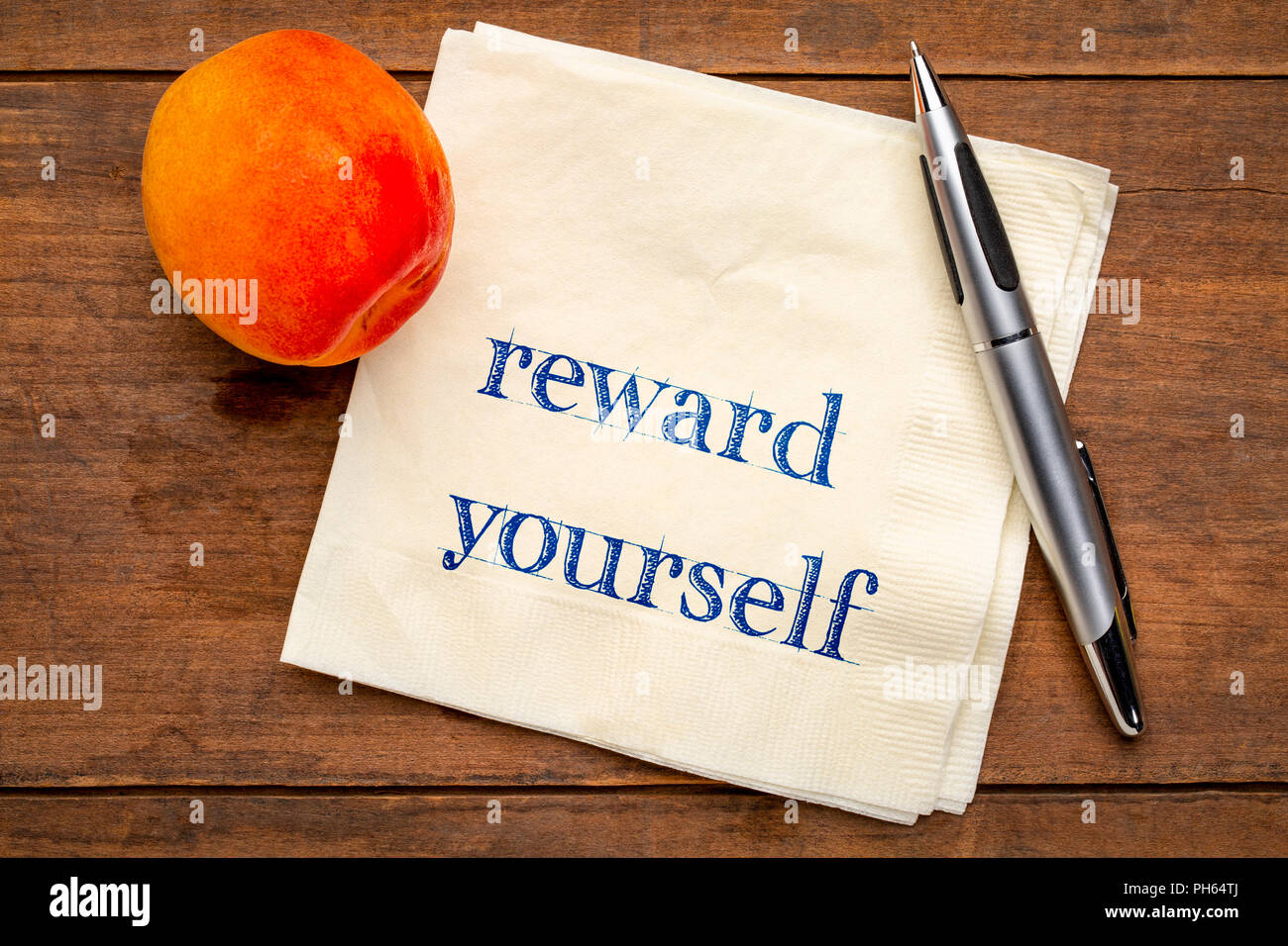 reward yourself reminder - handwriting on a napkin with a fresh apricot ...