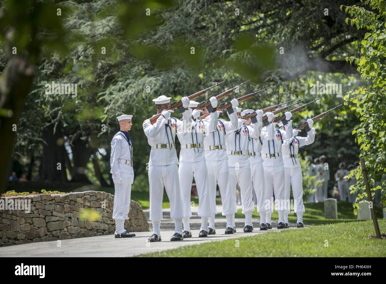 U.S. Navy Ceremonial Guard firing party fires a 3-rifle volley during ...