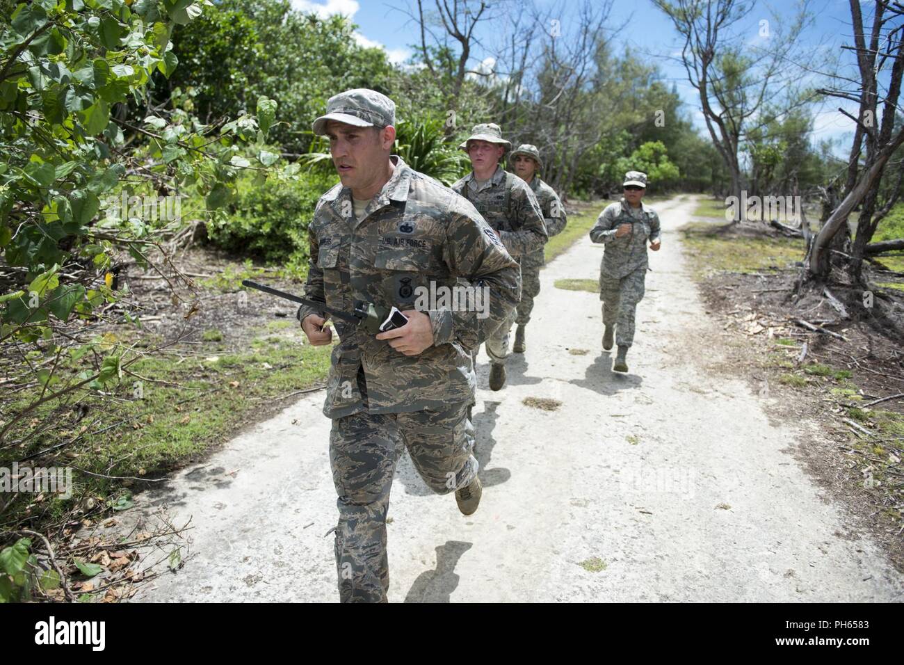 A team of competitors runs for the finish during the land navigation ...