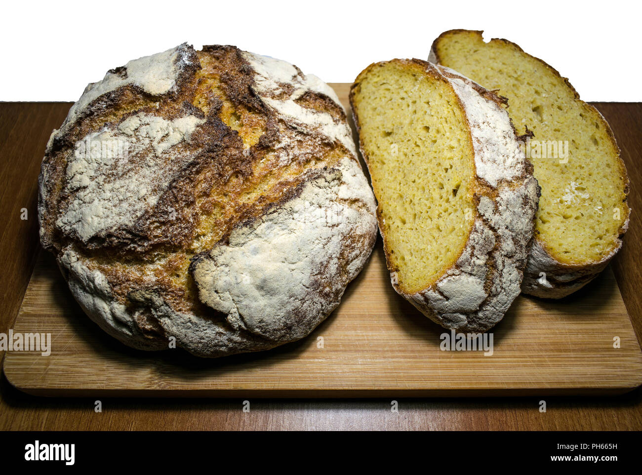 Round corn bread and slices on a cutting board Isolated in a white ...