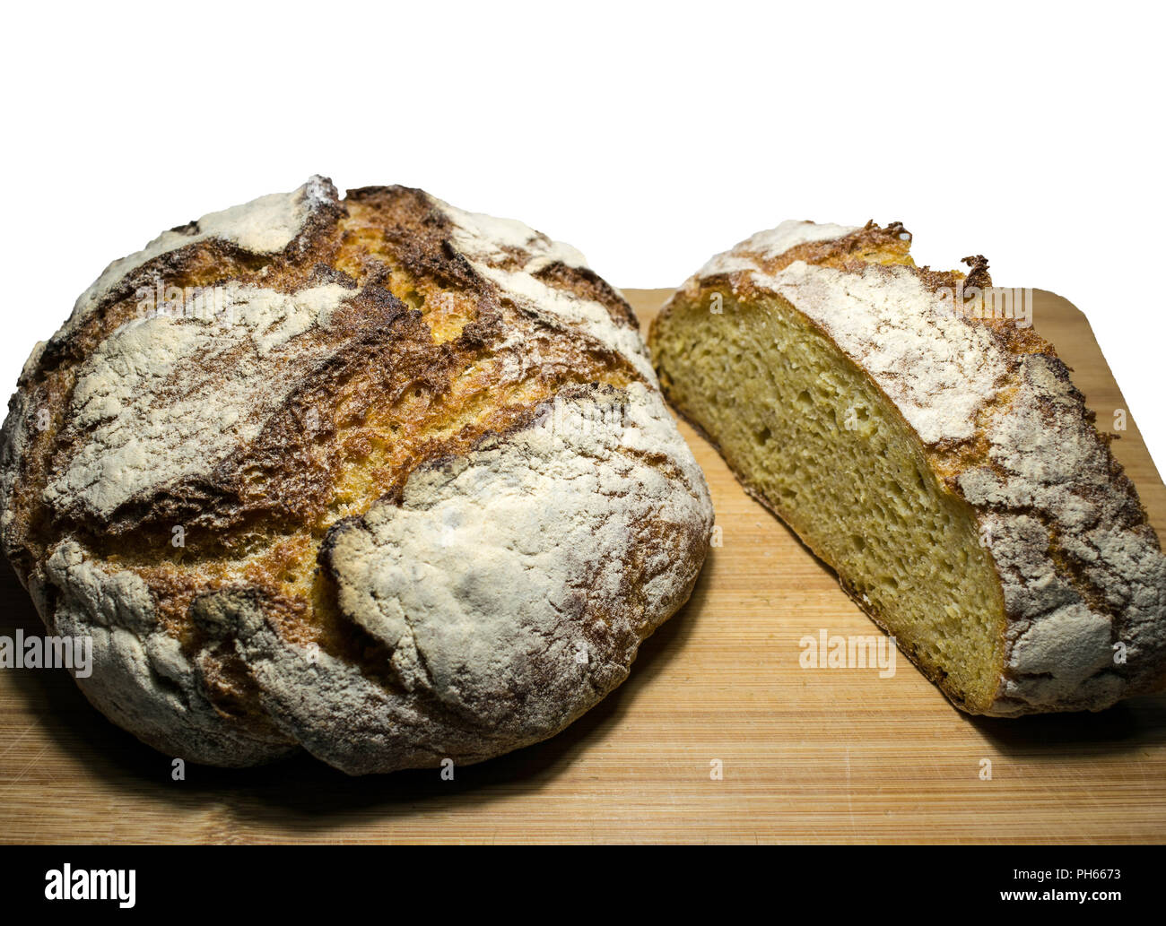 Round corn bread and slices on a cutting board Isolated in a white ...