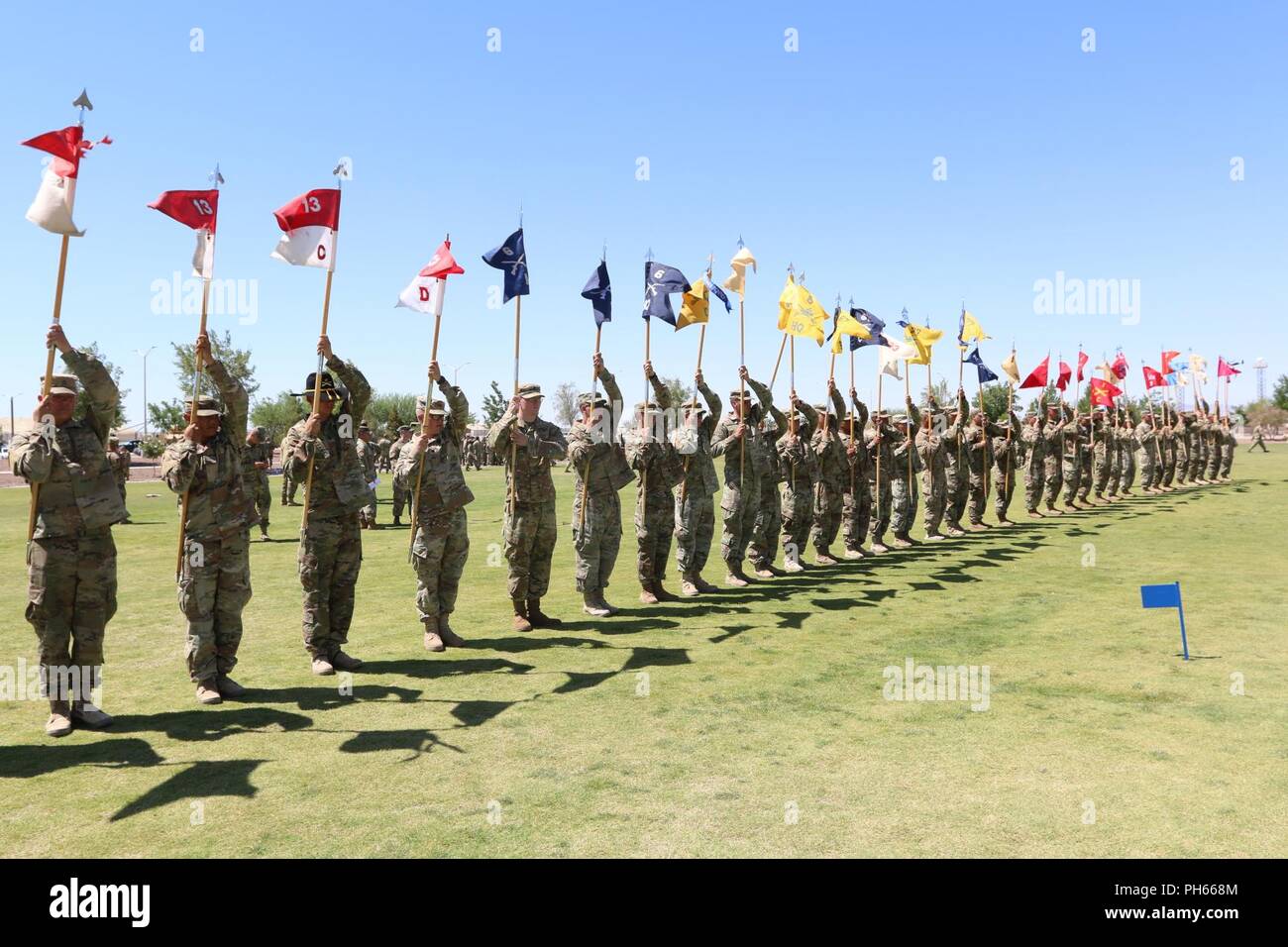 Soldiers with 3rd Armored Brigade Combat Team, 1st Armored Division lift up their guidons during ...