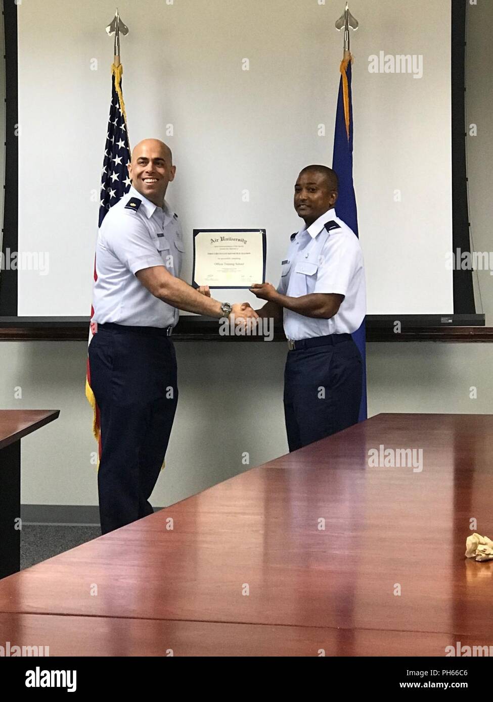 1st Lieutenant Kenneth Ellison receives his diploma from Maj. Francisco ...
