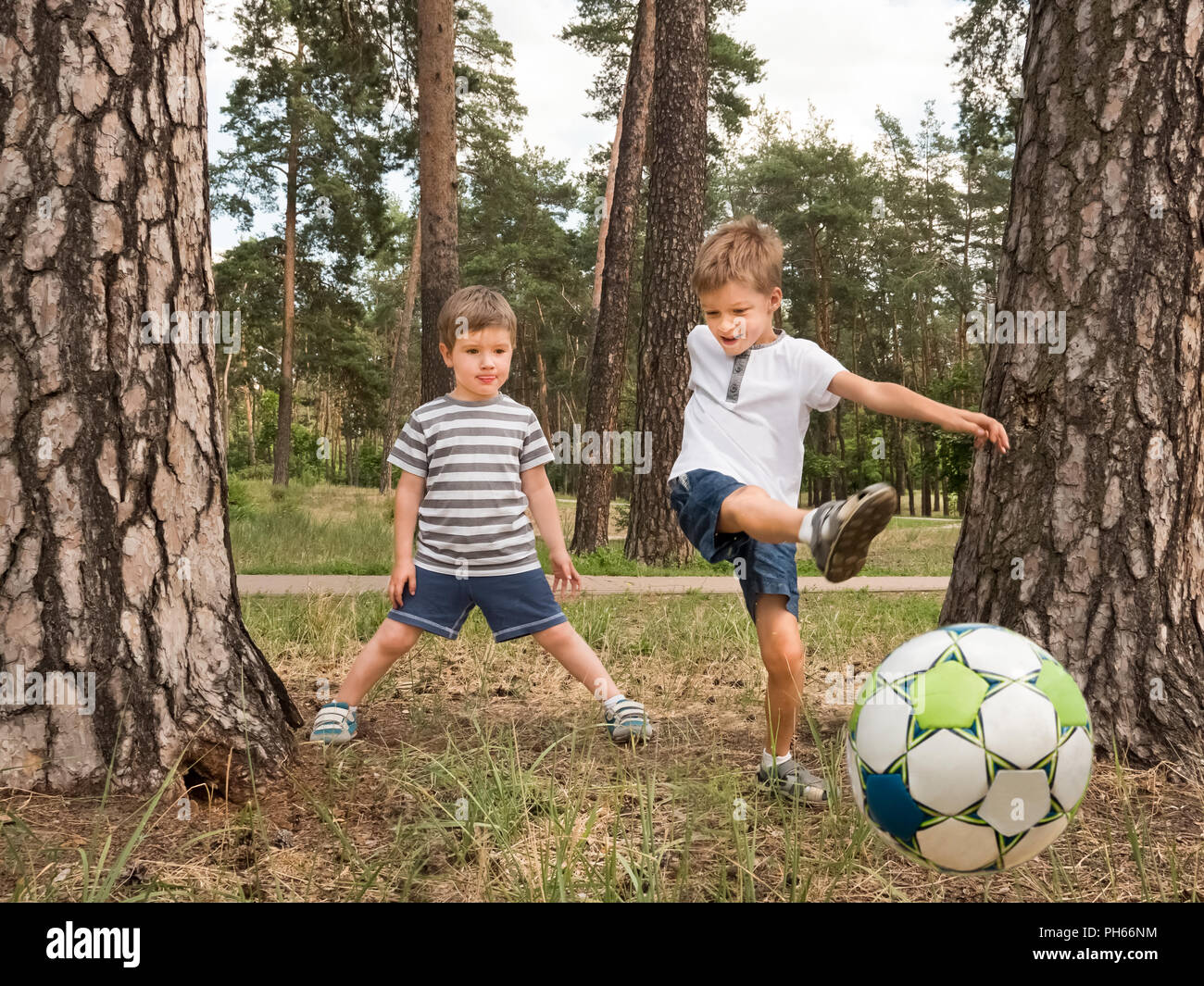 Children playing soccer outdoor. Leisure activities for children Stock ...