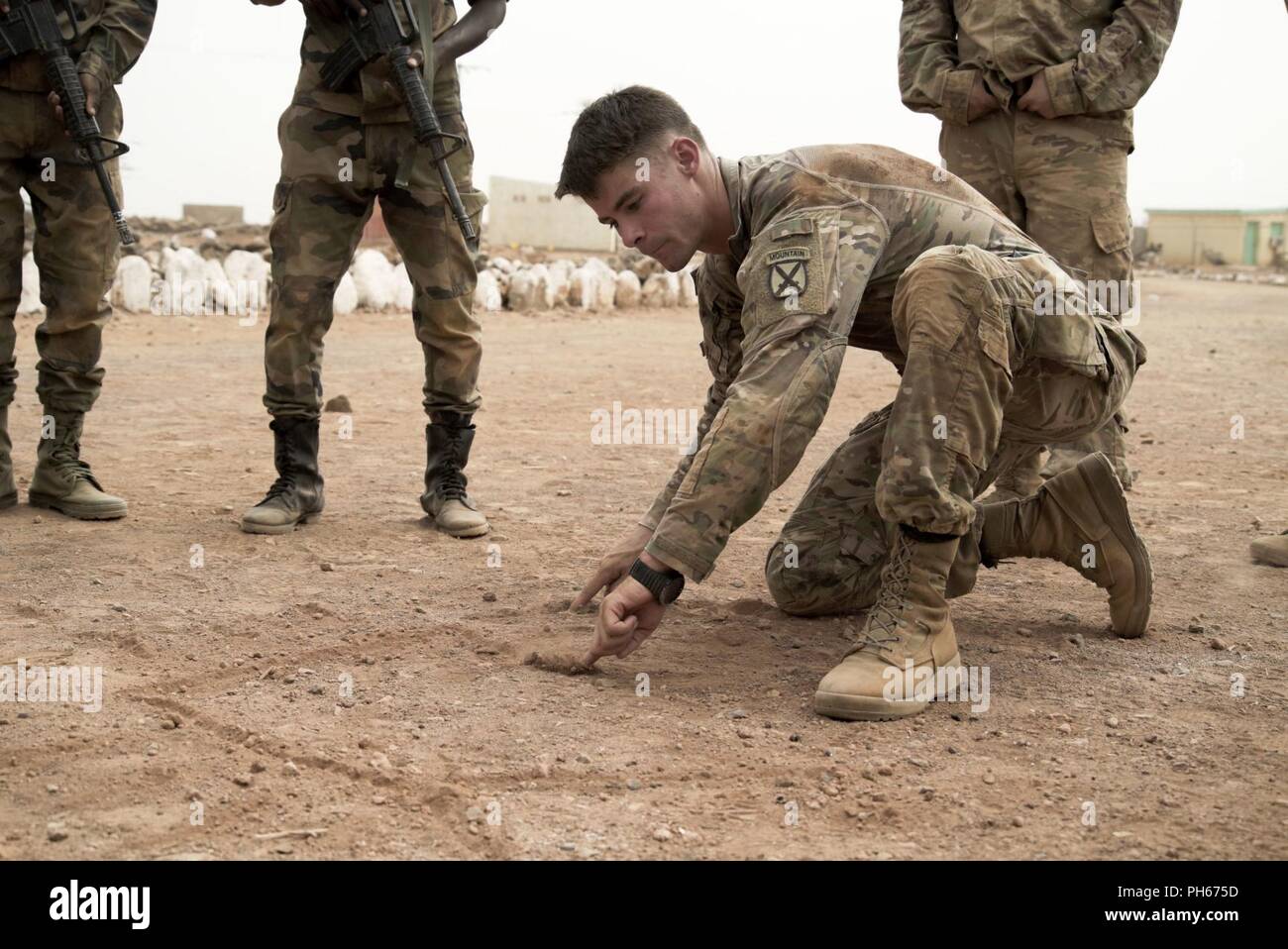A U.S. Army infantryman from the 10th Mountain Division maps out ...