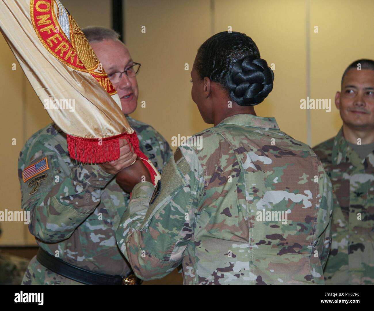 Col. Kim M. Thomas, outgoing commander of the 408th Contracting Support Brigade, passes the unit ...