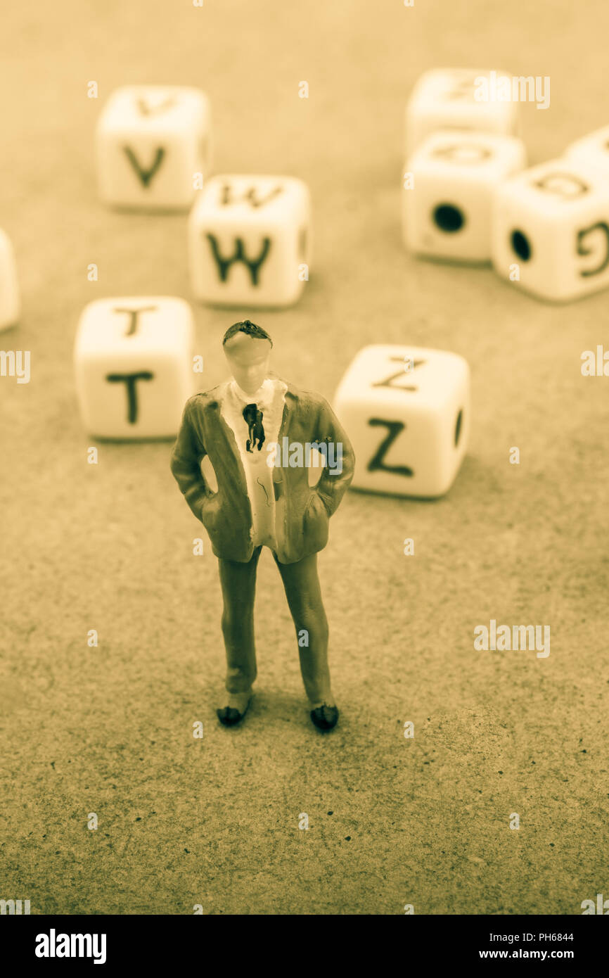 Figurine standing in front of the colorful alphabet letter cubes Stock ...