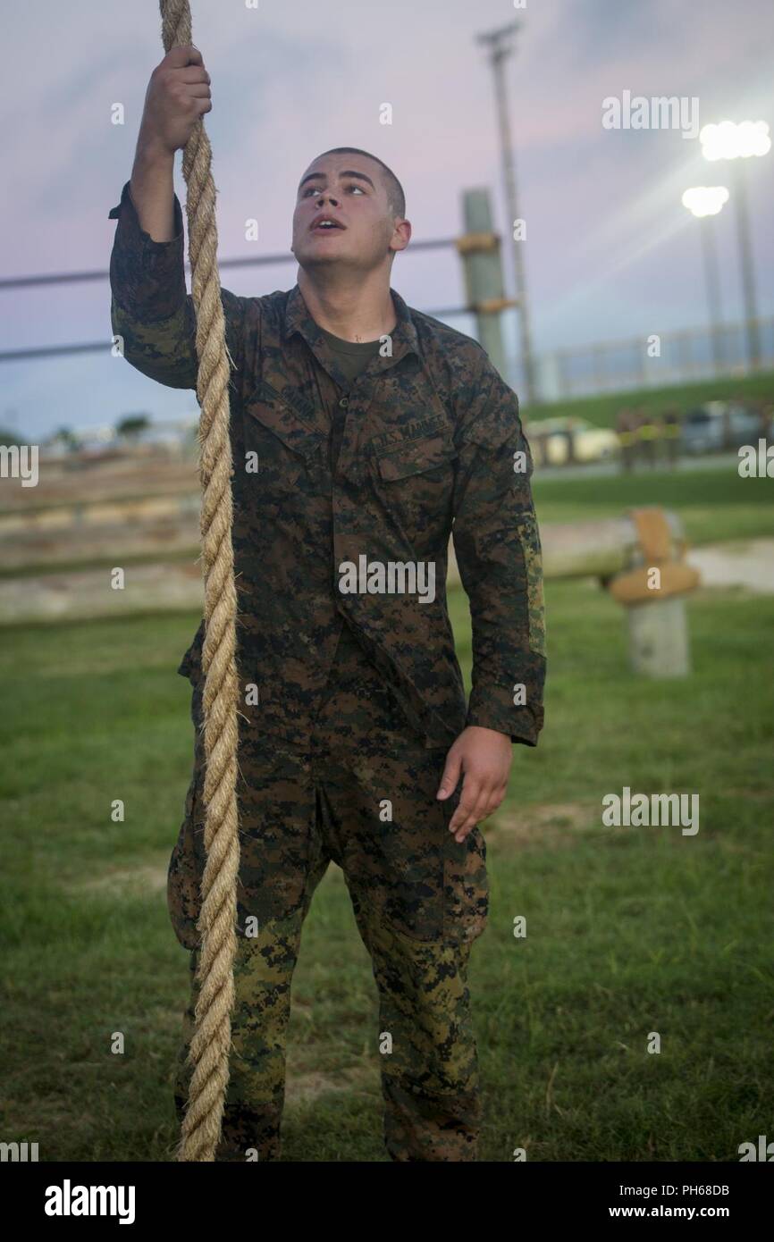 Lance Cpl. Matthew Cadena prepares to climb a rope at the end of the ...