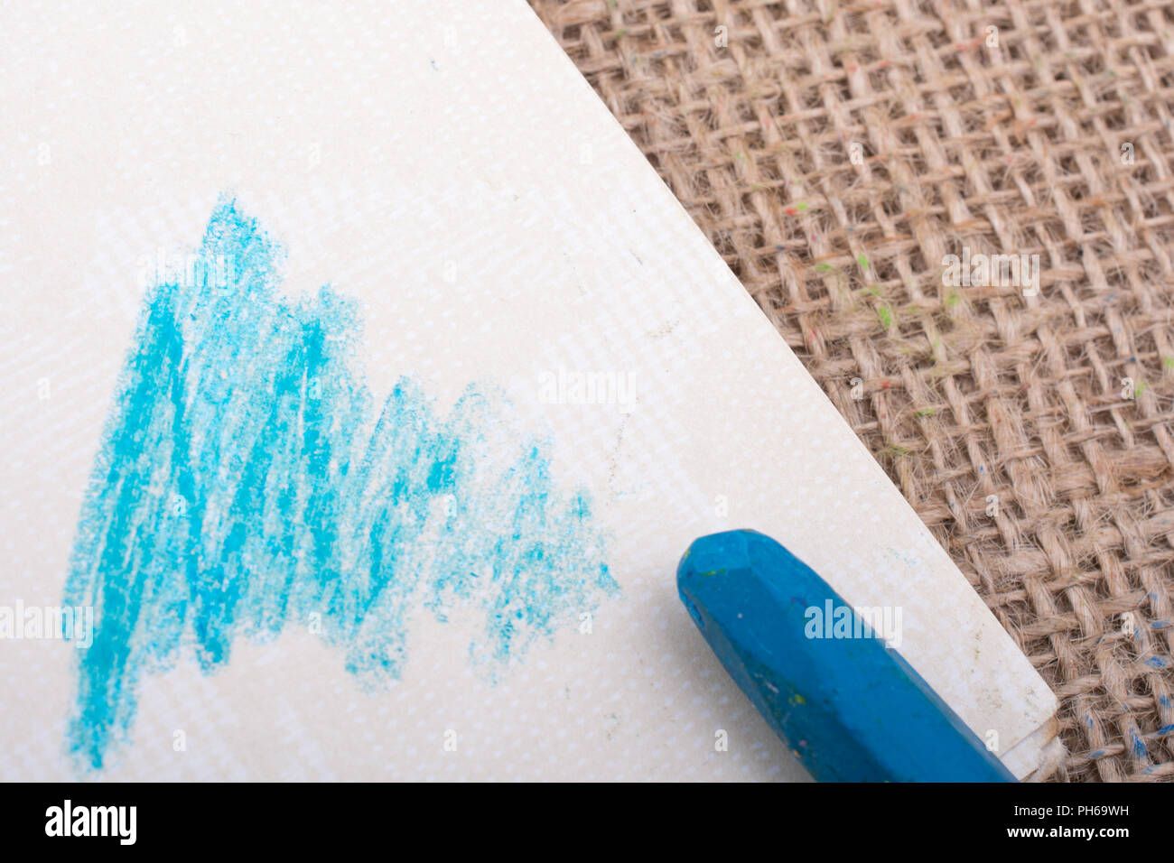 Blue color crayon placed on a notebook Stock Photo - Alamy