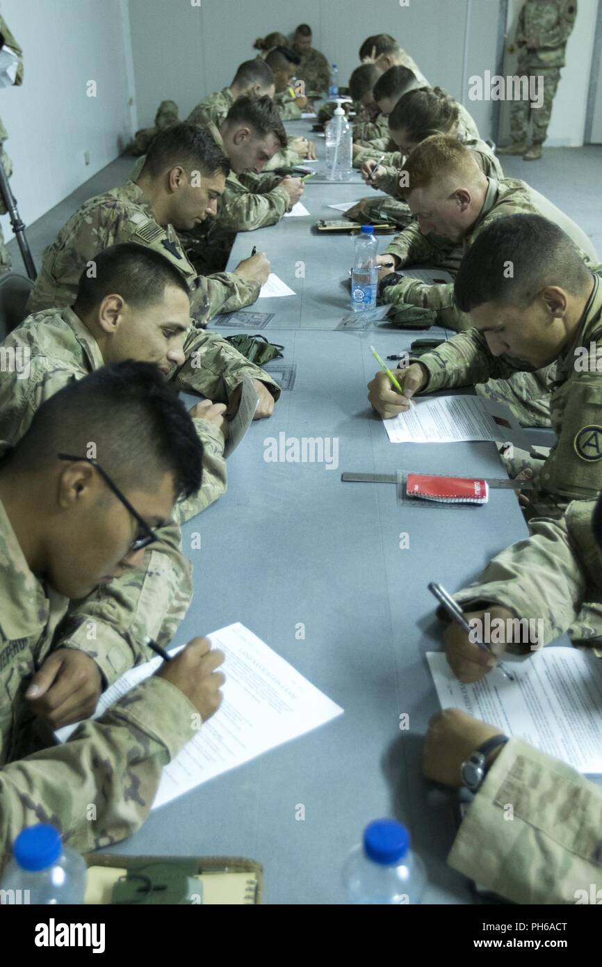 U.S. Army Soldiers take a written knowledge test at Forward Operating ...