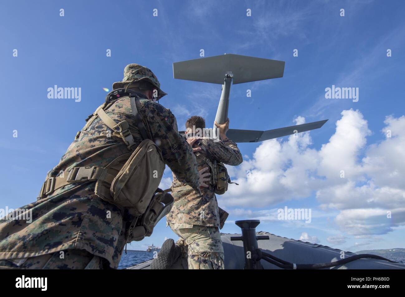 Sergeant Vincent McGinn, from Riverside California, (left) assists ...