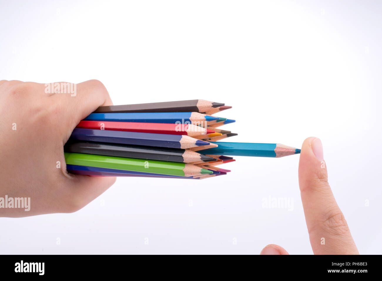 Hand holding color pencils on a white background Stock Photo - Alamy