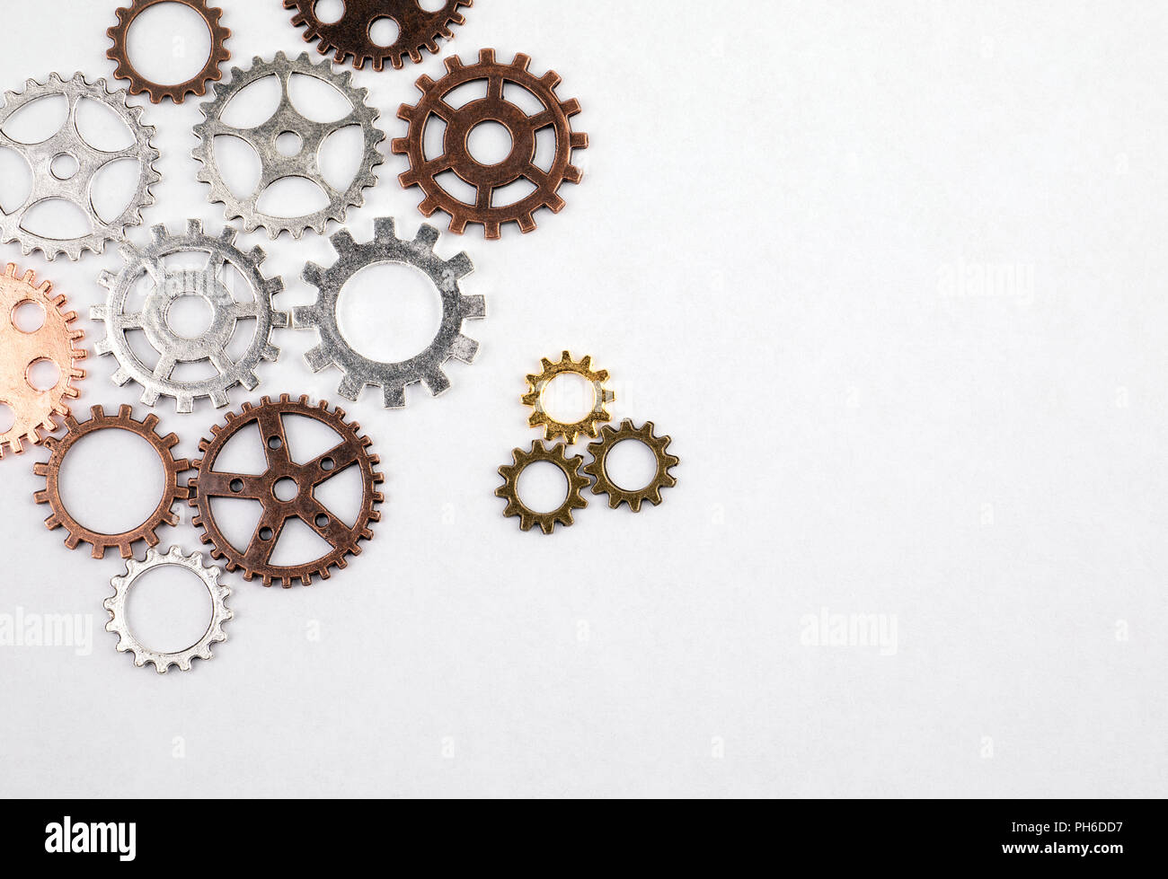 Different sizes and colored gears on a white background Stock Photo - Alamy