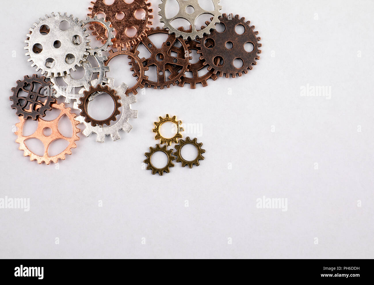 Different sizes and colored gears on a white background Stock Photo - Alamy