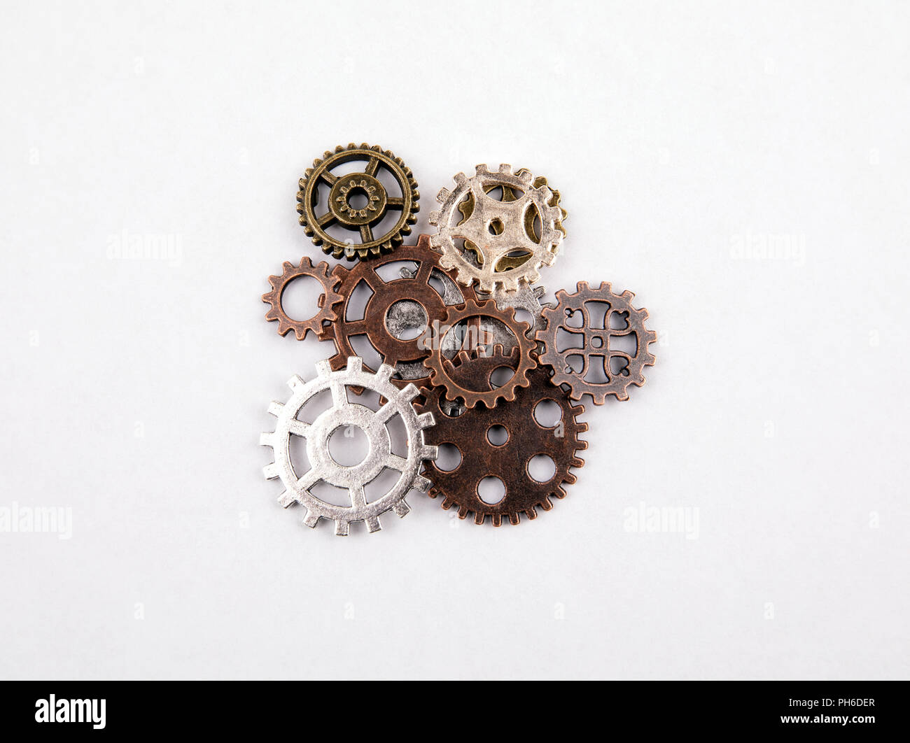 Different sizes and colored gears on a white background Stock Photo - Alamy