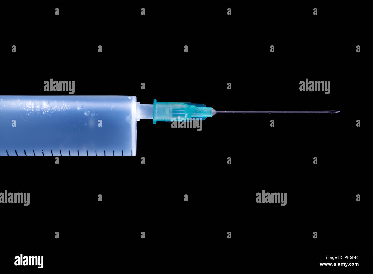 Blue illuminated syringe with sharp needle close up. Isolated on black ...