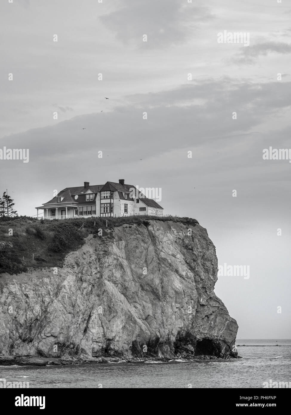 a big mansion house on a cliff in percé, gaspesie, quebec, canada B&W ...