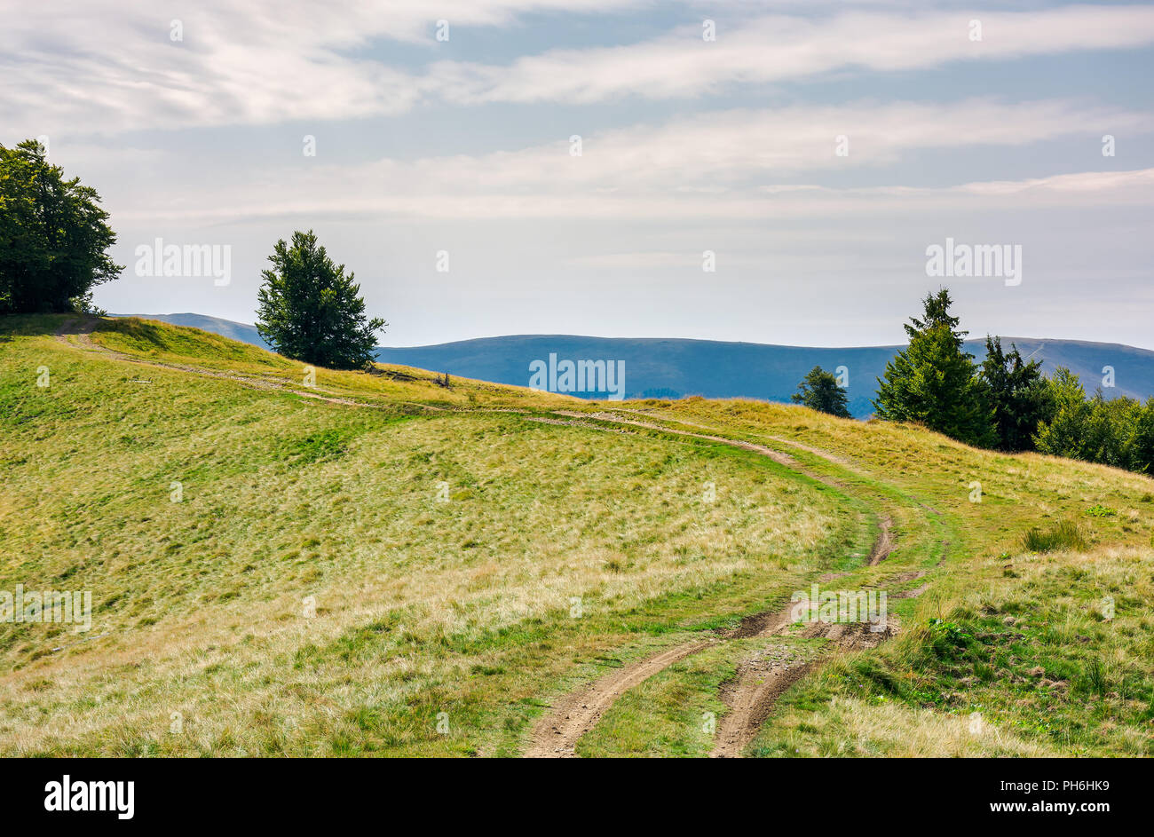country road through mountain ridge. lovely countryside background ...