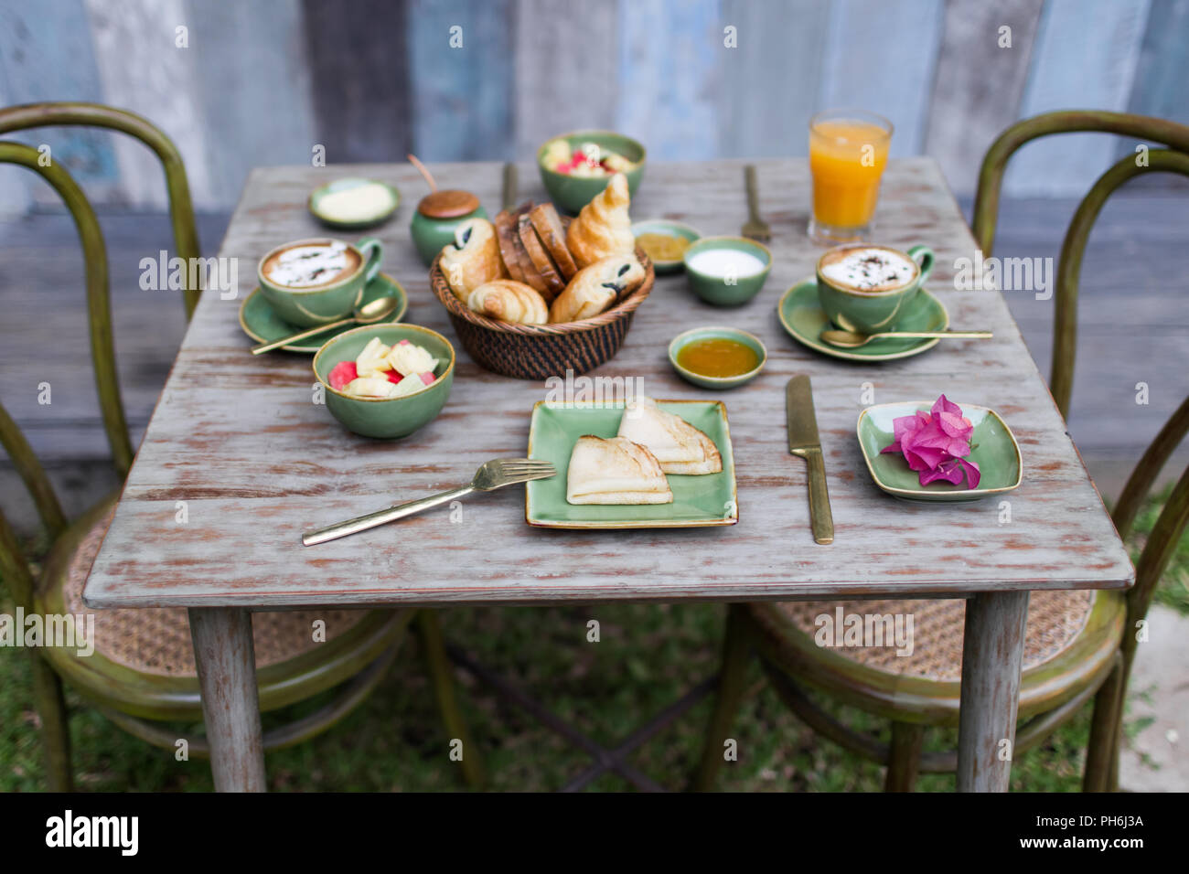 Breakfast outside in garden on vintage wooden table Stock Photo - Alamy