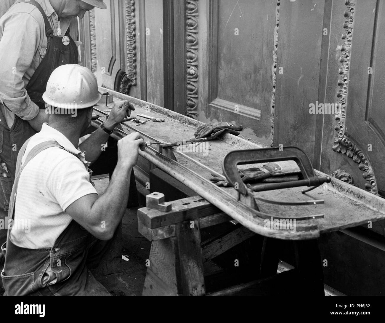 Workman assembling a typical guard at the boiler plate level of the ...