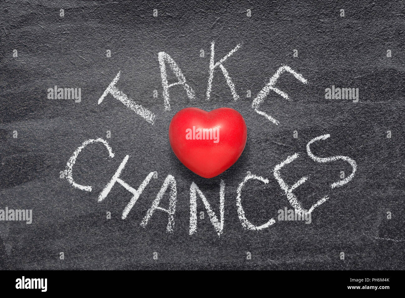 take chances phrase handwritten on chalkboard with red heart symbol ...