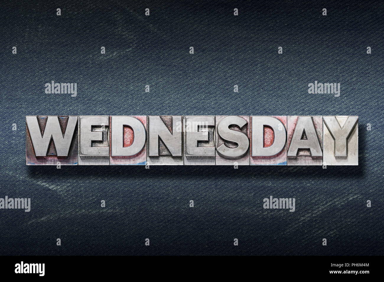 Wednesday word made from metallic letterpress on dark jeans background ...