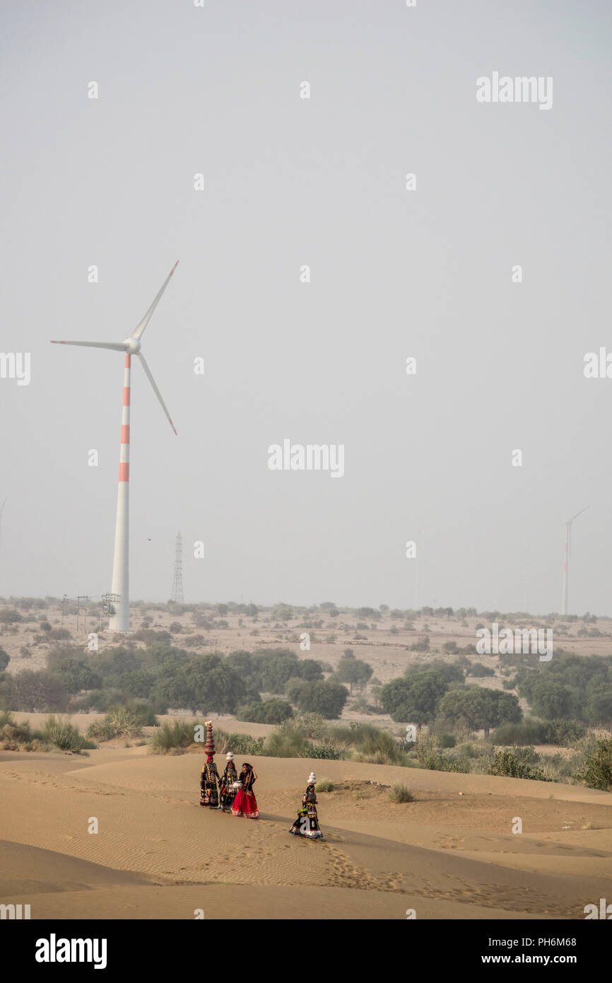 Nomadic women in the Thar Desert with wind turbine in the background ...