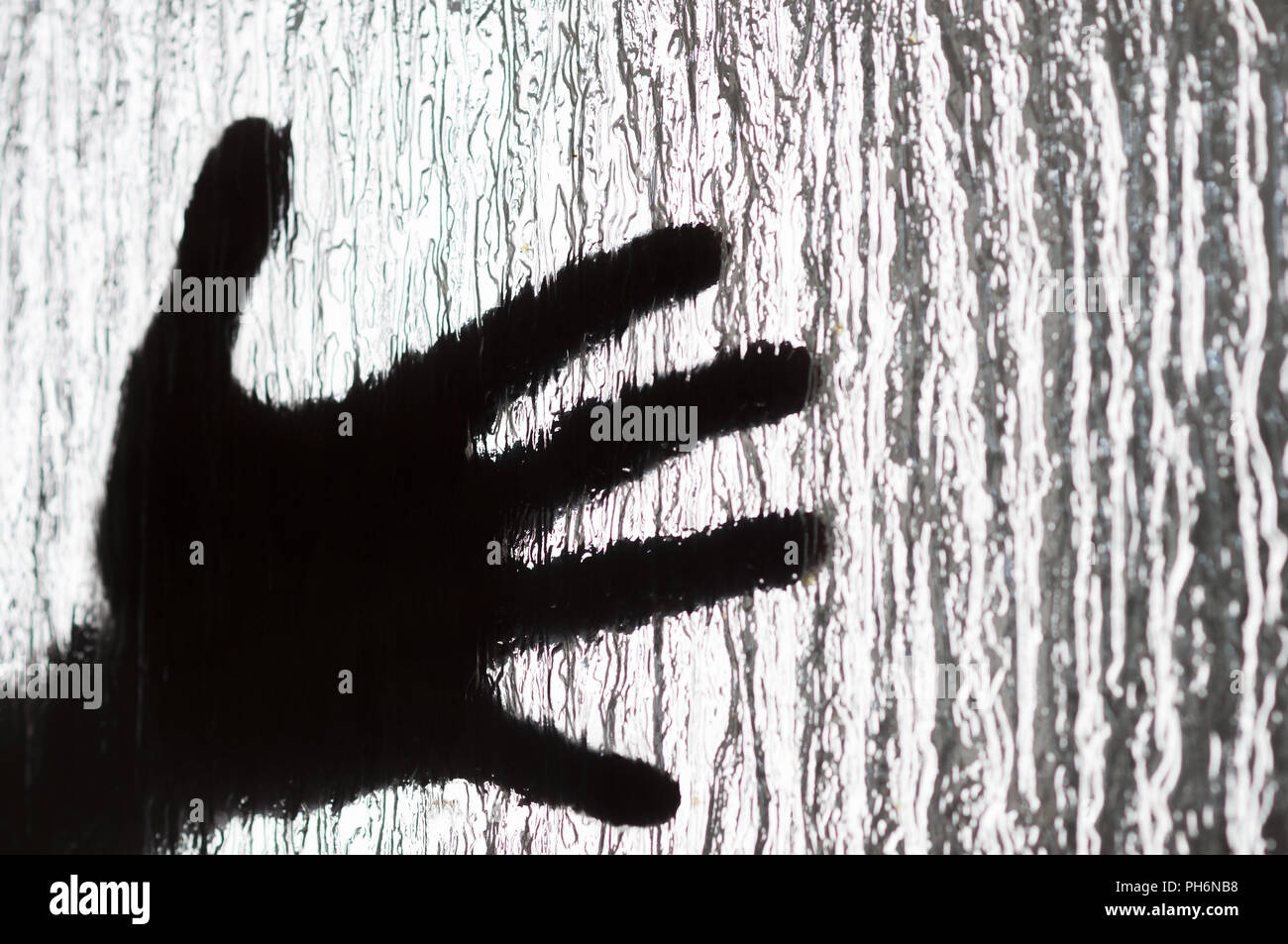 Human hand behind glass pane hi-res stock photography and images - Alamy