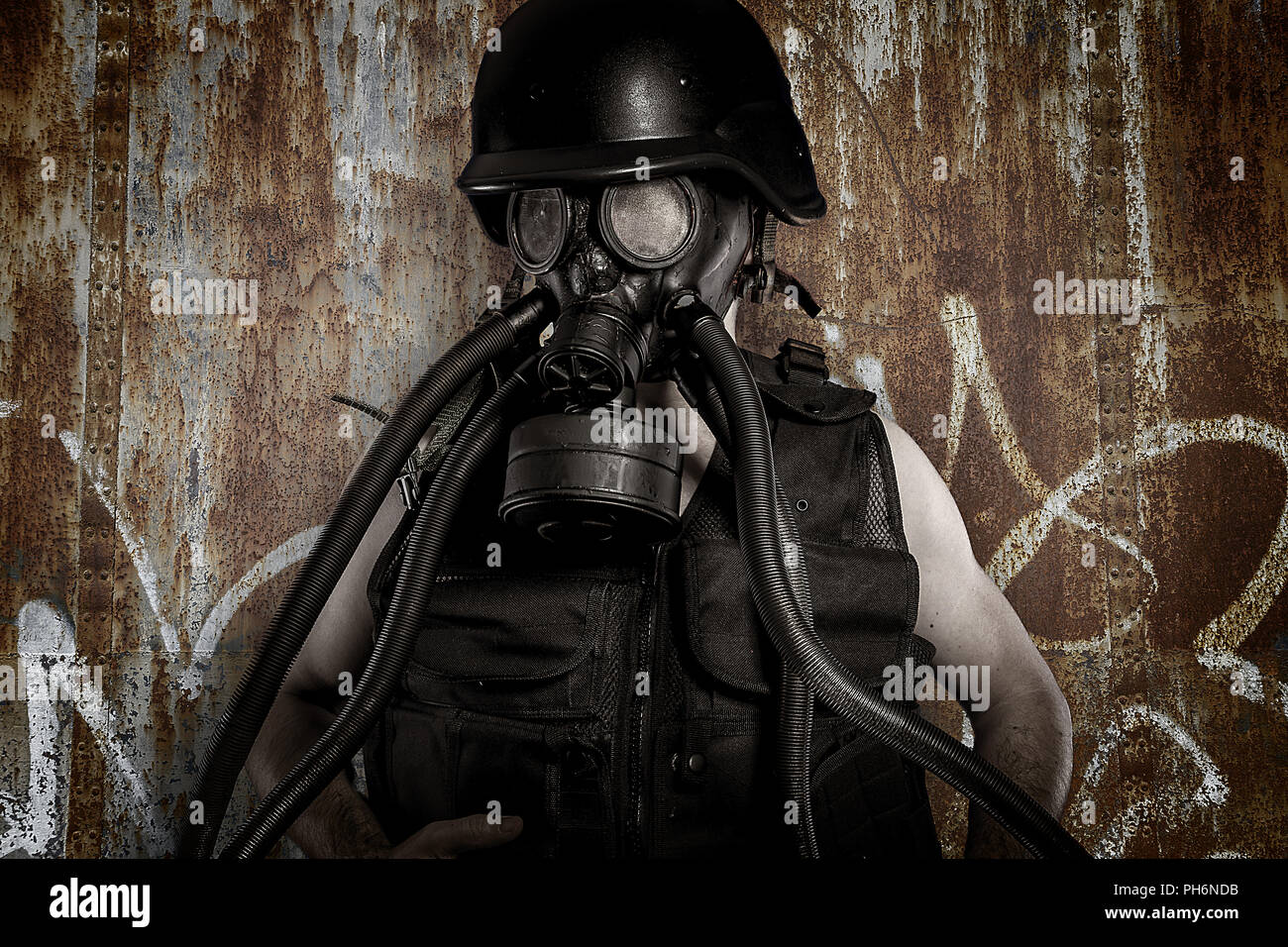 Man with gas mask over dirty texture iron wall Stock Photo - Alamy