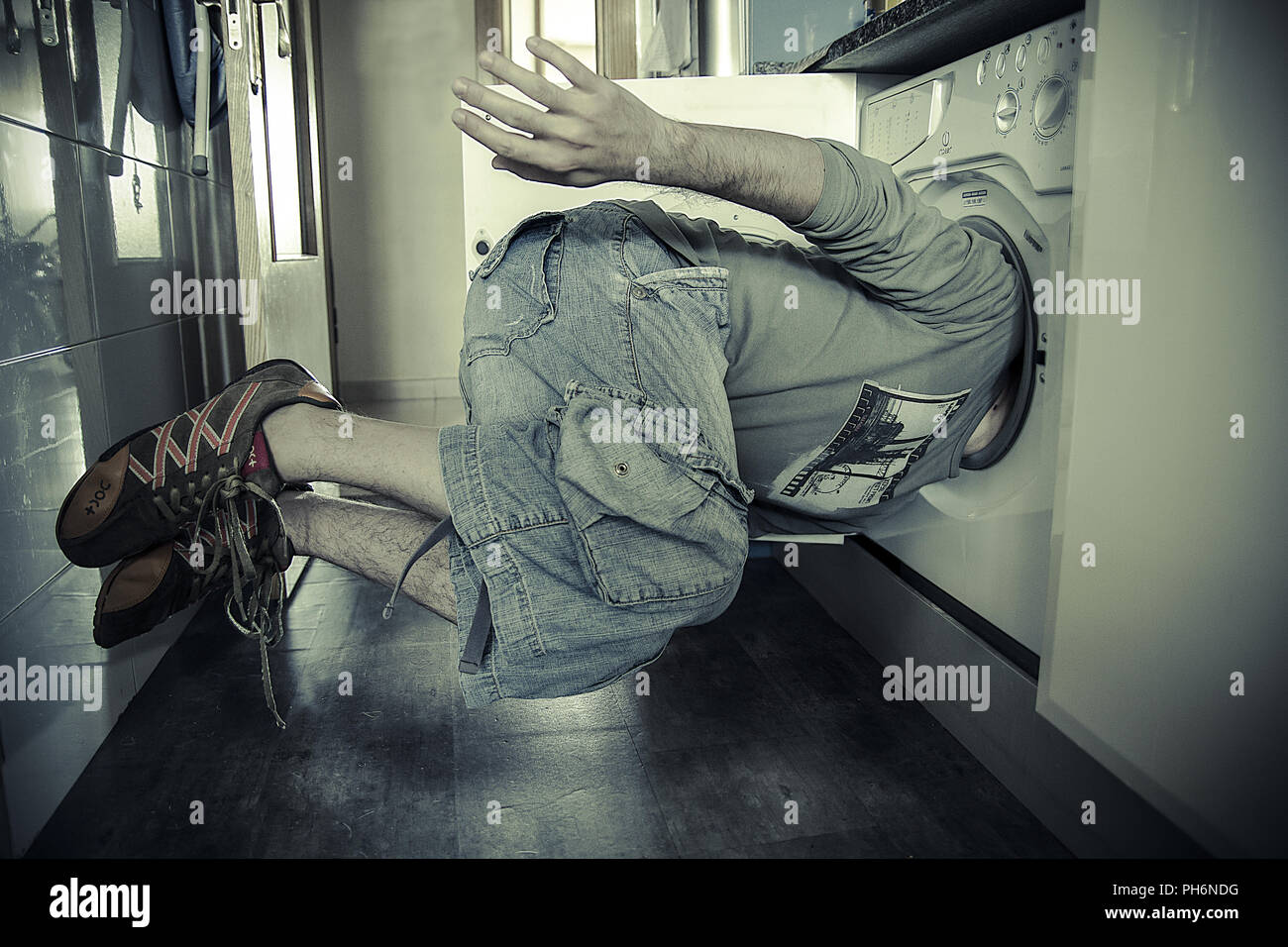 man flying with his head stuck in a washing machine Stock Photo - Alamy