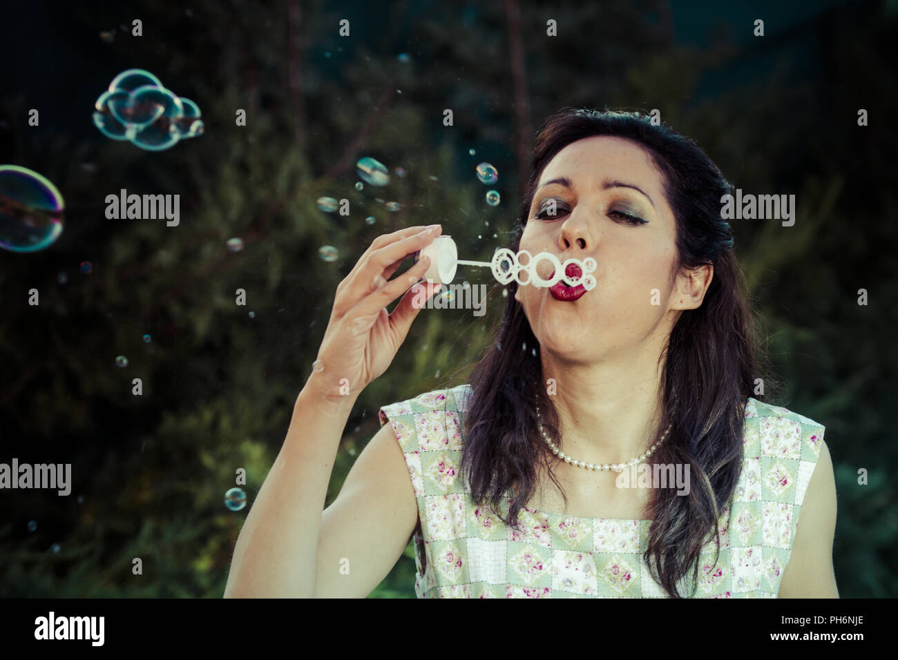 a beautiful woman blowing bubbles. spring season, rural scene Stock ...