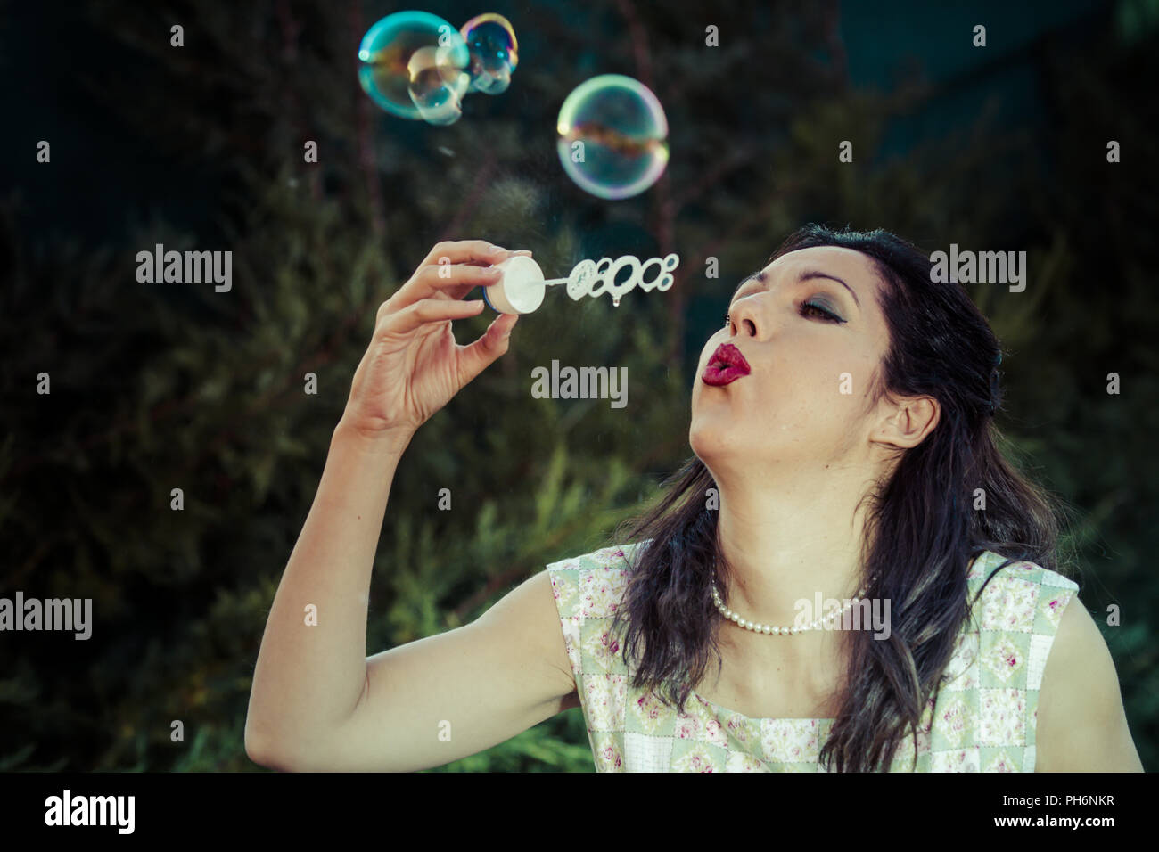 a beautiful woman blowing bubbles. spring season, rural scene Stock ...
