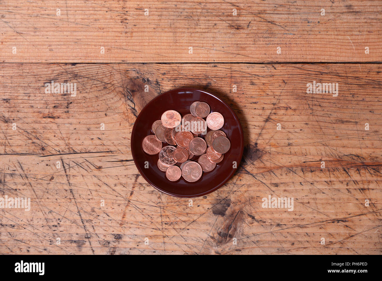 Tipping Euro Plates Stock Photo - Alamy