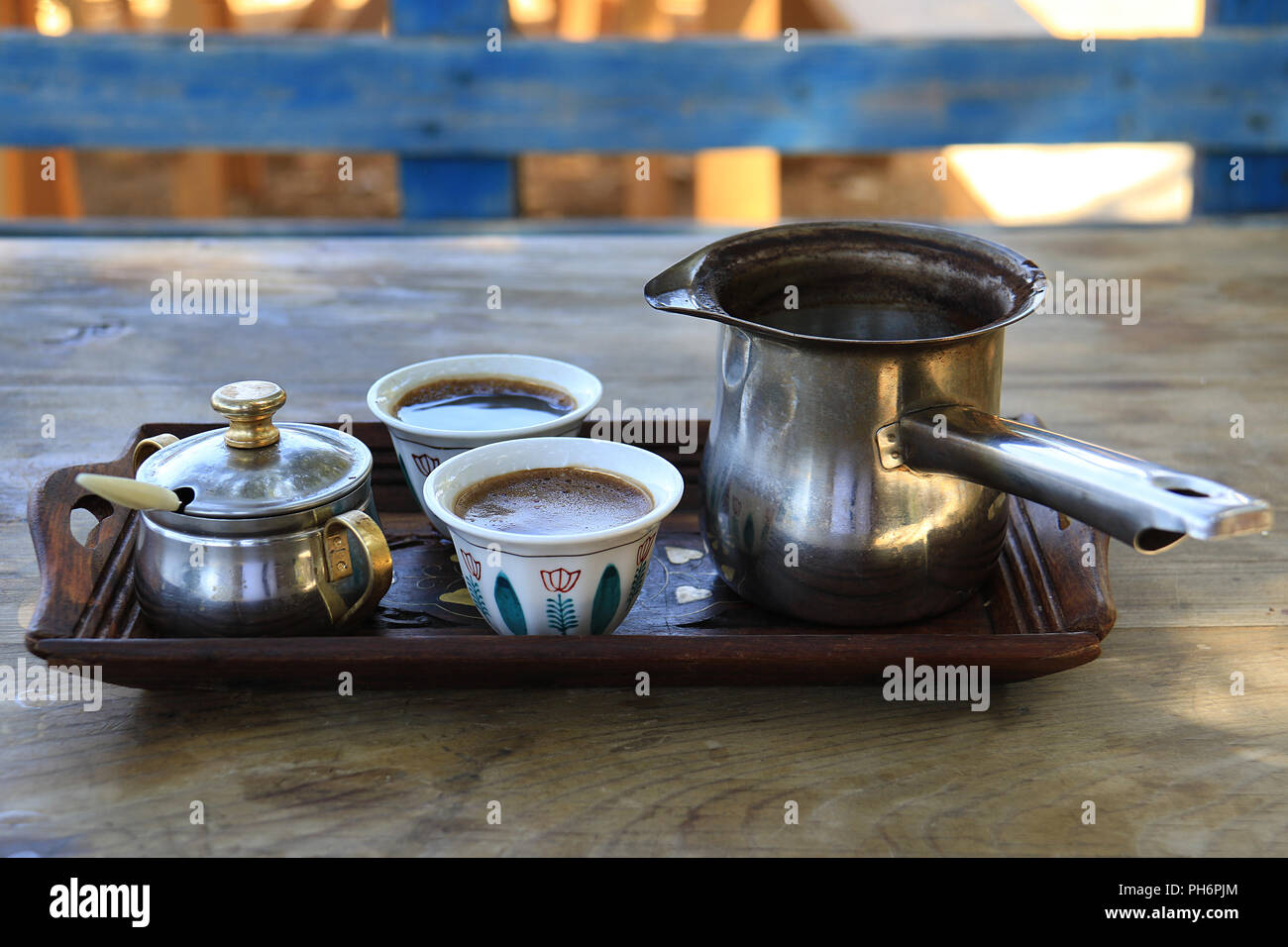 A tray with two Lebanese traditional coffee cups with a coffee Kettle ...