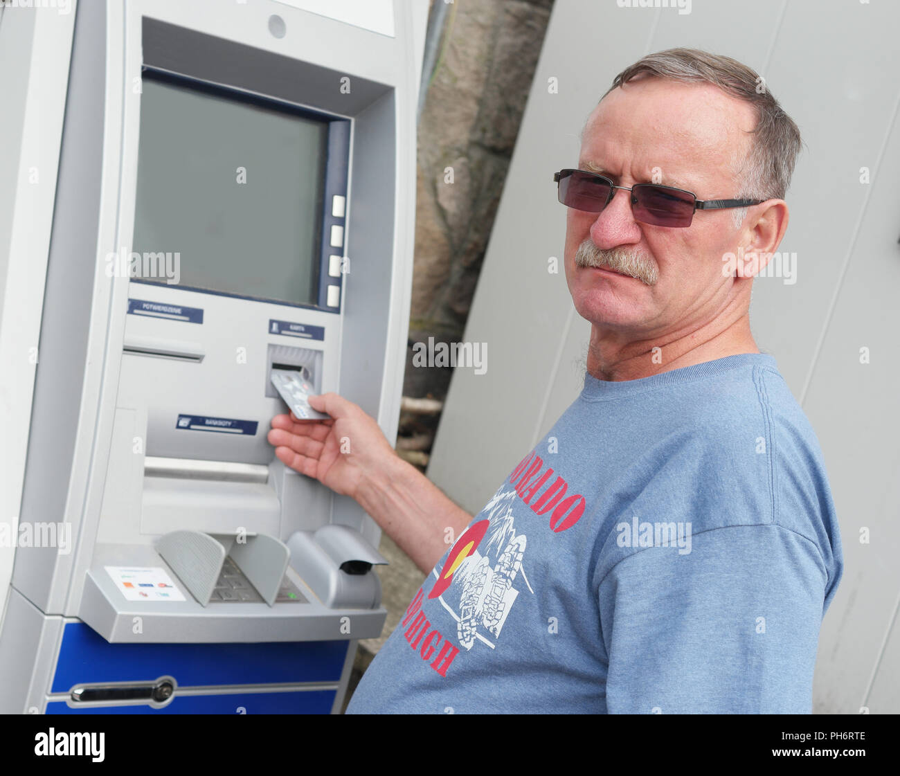 Man withdrawing money hi-res stock photography and images - Alamy