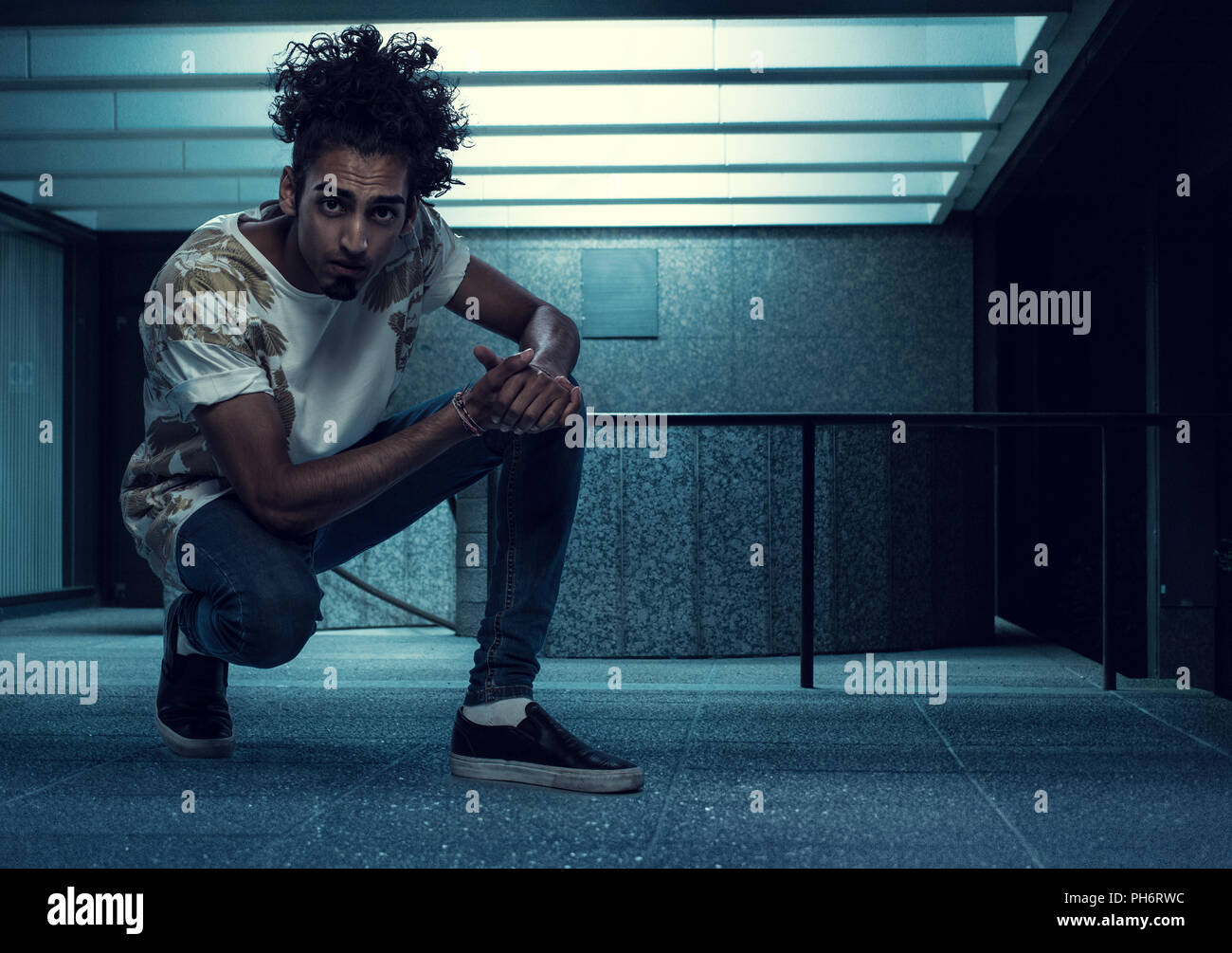 Squatting male figure hi-res stock photography and images - Alamy