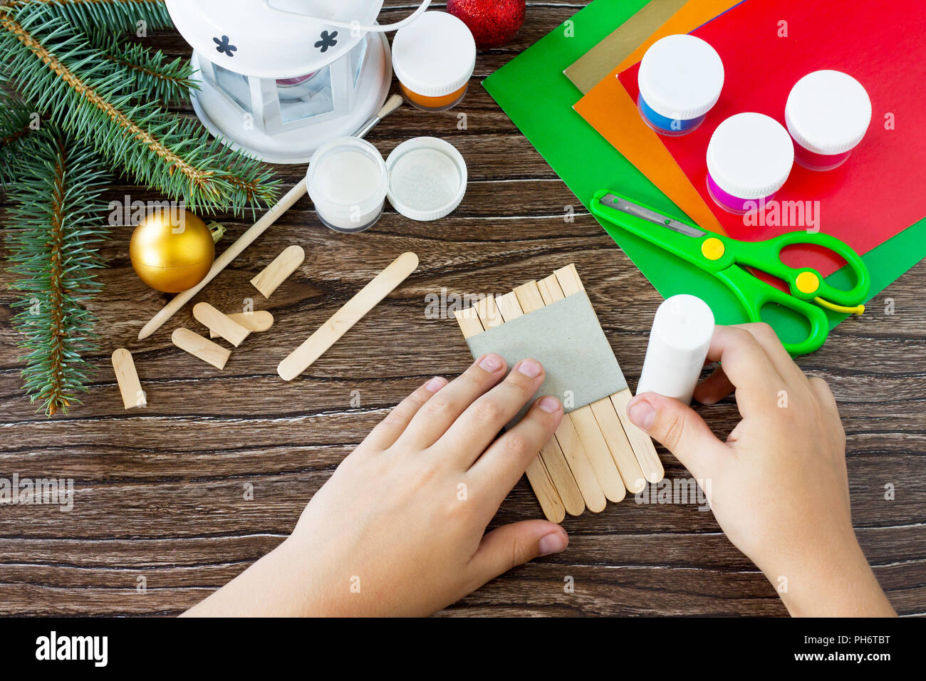 The child glues the parts Christmas decoration or Christmas gift ...