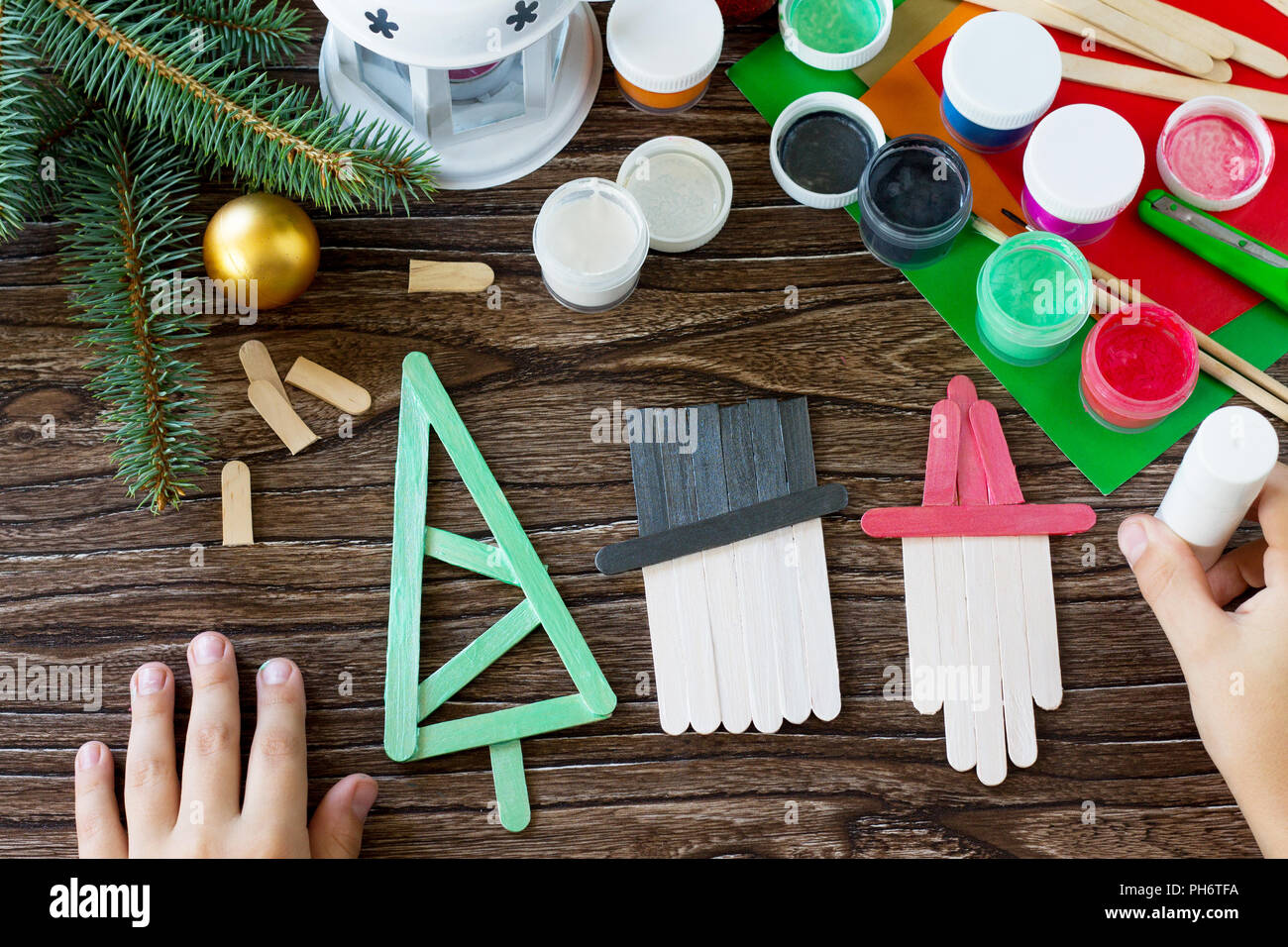 The child glues the parts Christmas decoration or Christmas gift ...