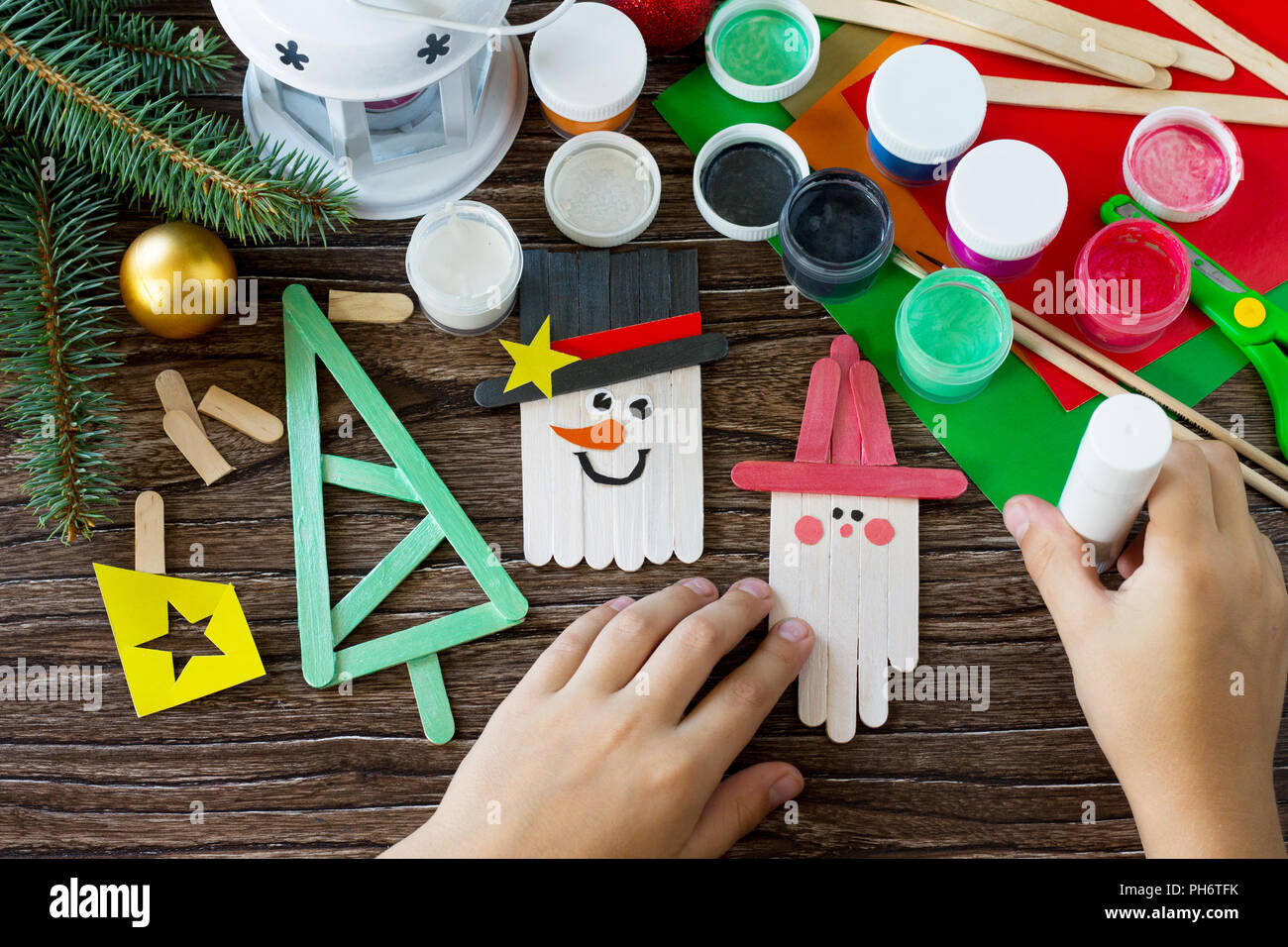 The child glues the parts Christmas decoration or Christmas gift ...