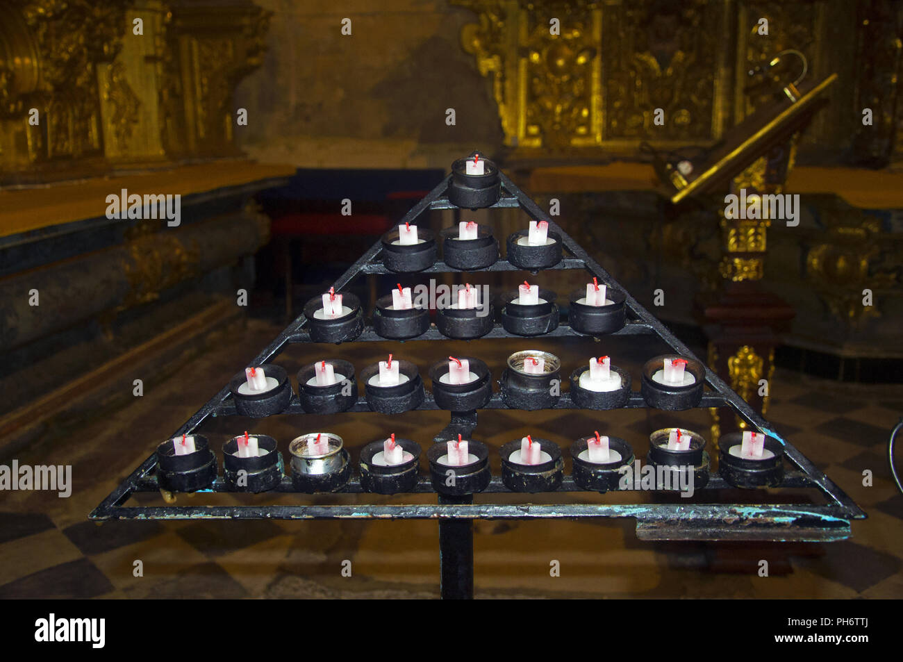 Triangle chandelier with small white candles in the church Stock Photo ...