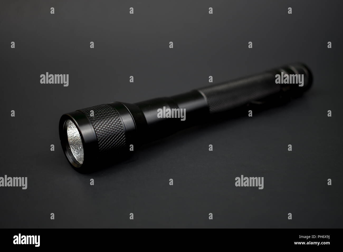 Black LED flashlight on a black background Stock Photo - Alamy